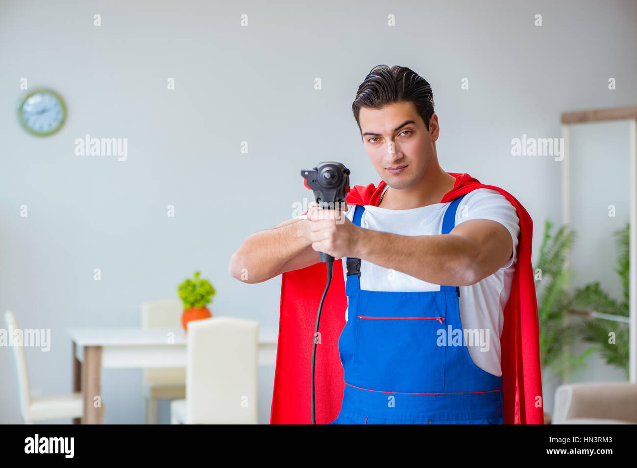 Super hero repairman working at home Stock Photo - Alamy
