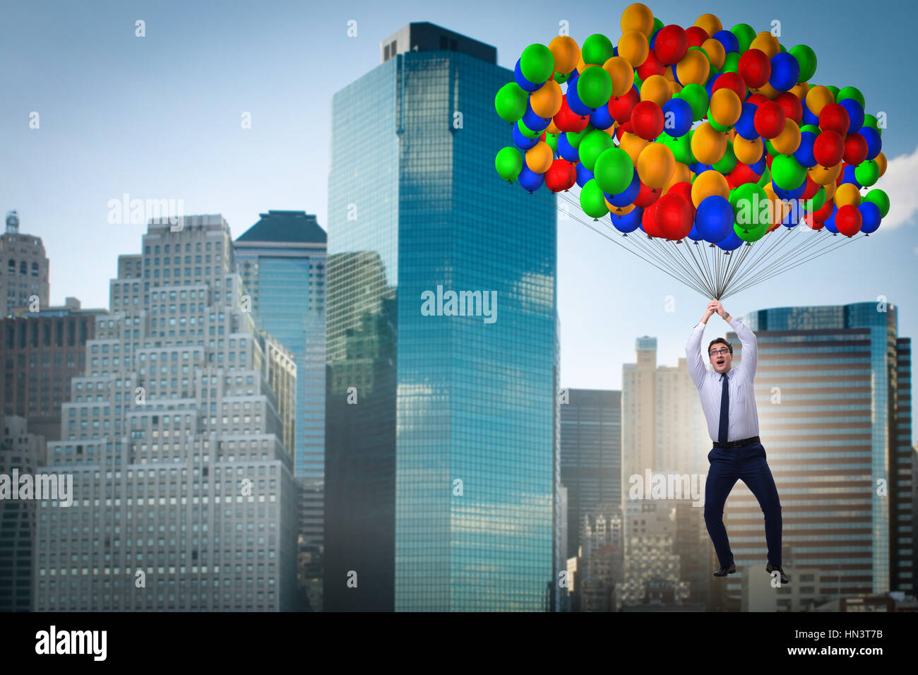 Businessman flying on balloons in challenge concept Stock Photo - Alamy