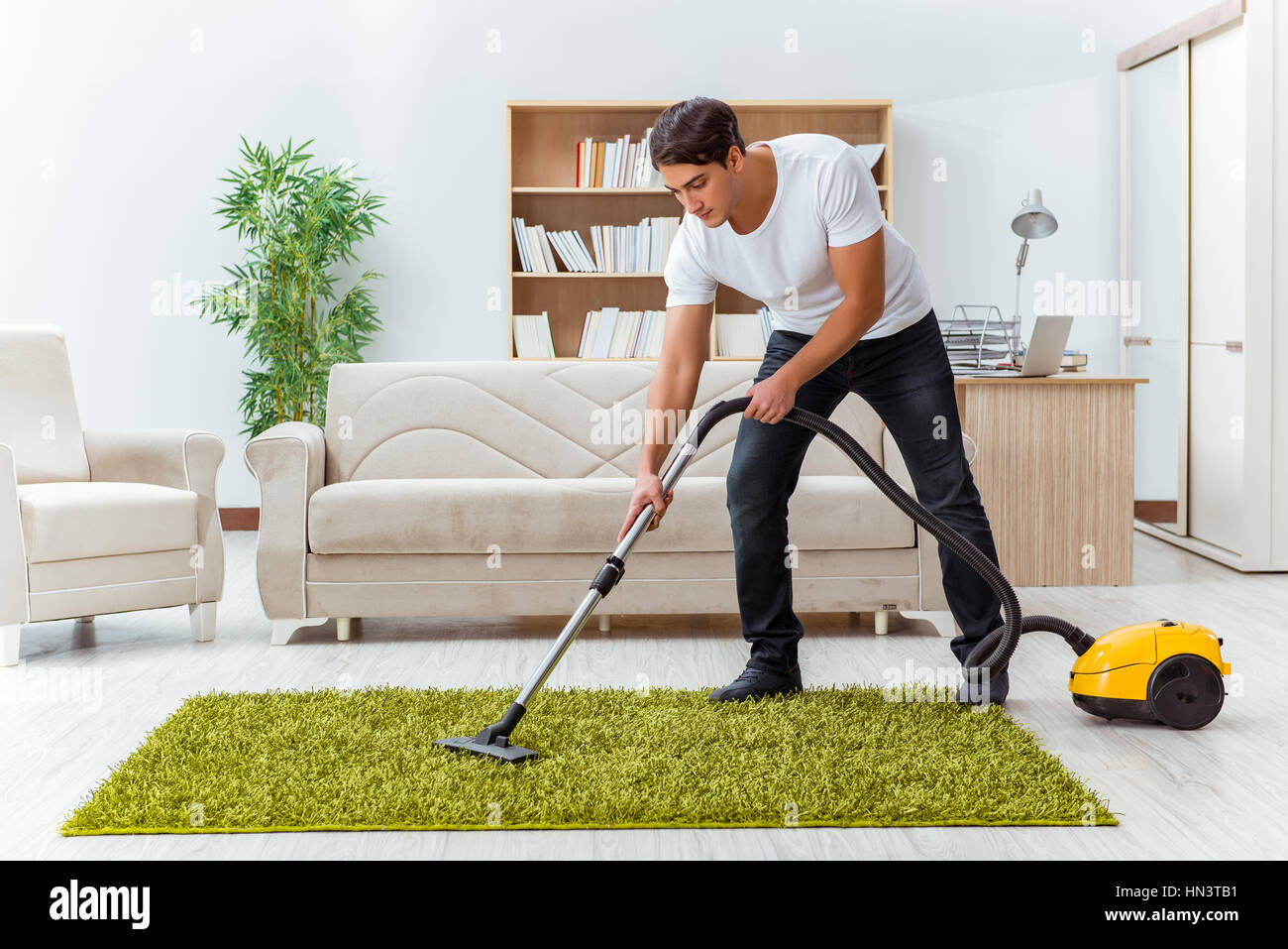Man husband cleaning the house helping wife Stock Photo - Alamy