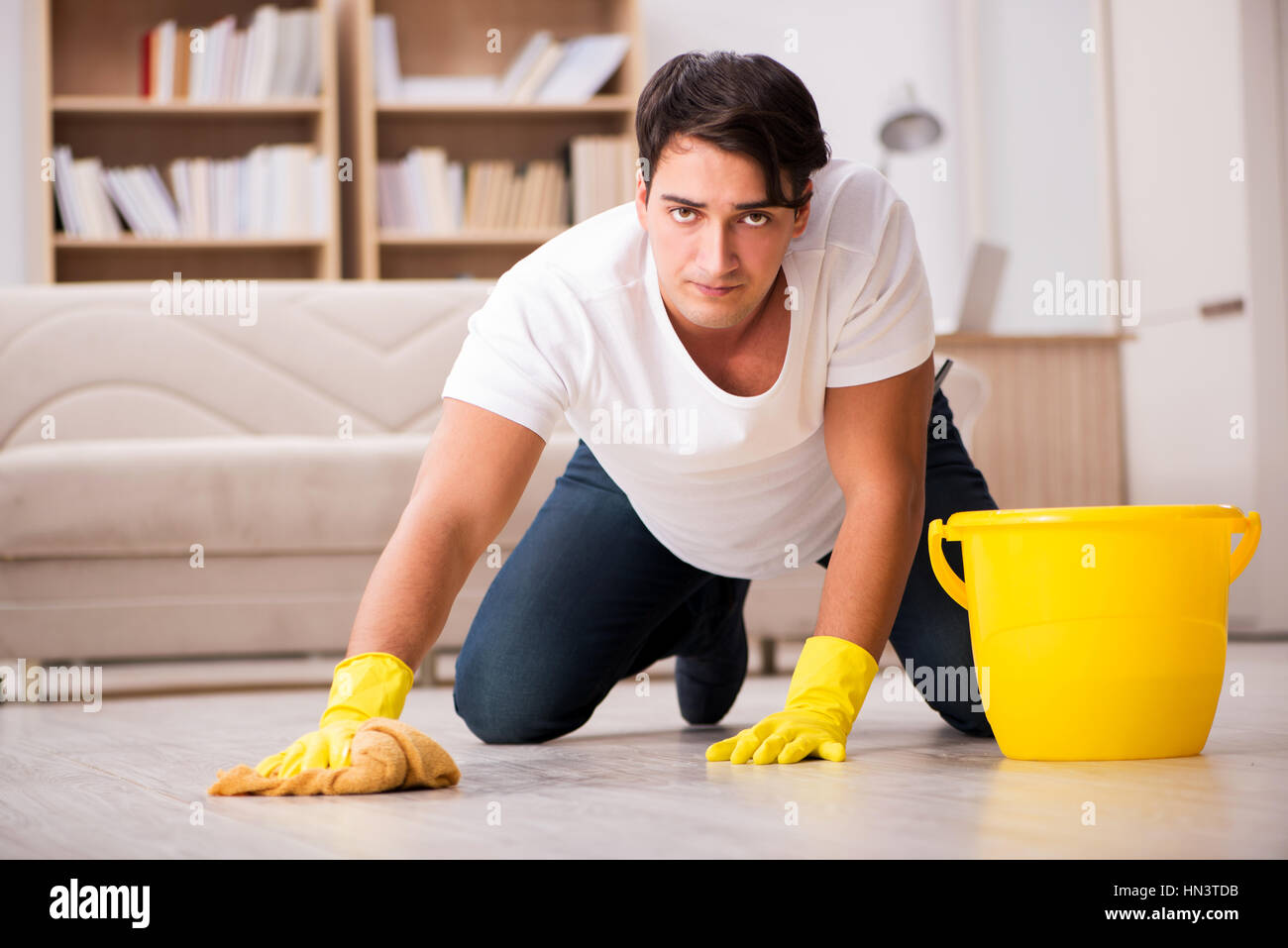 Man husband cleaning the house helping wife Stock Photo - Alamy