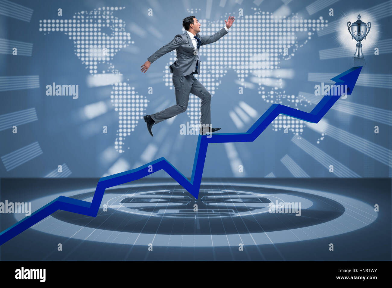 Businessman running towards prize cup trophy Stock Photo - Alamy