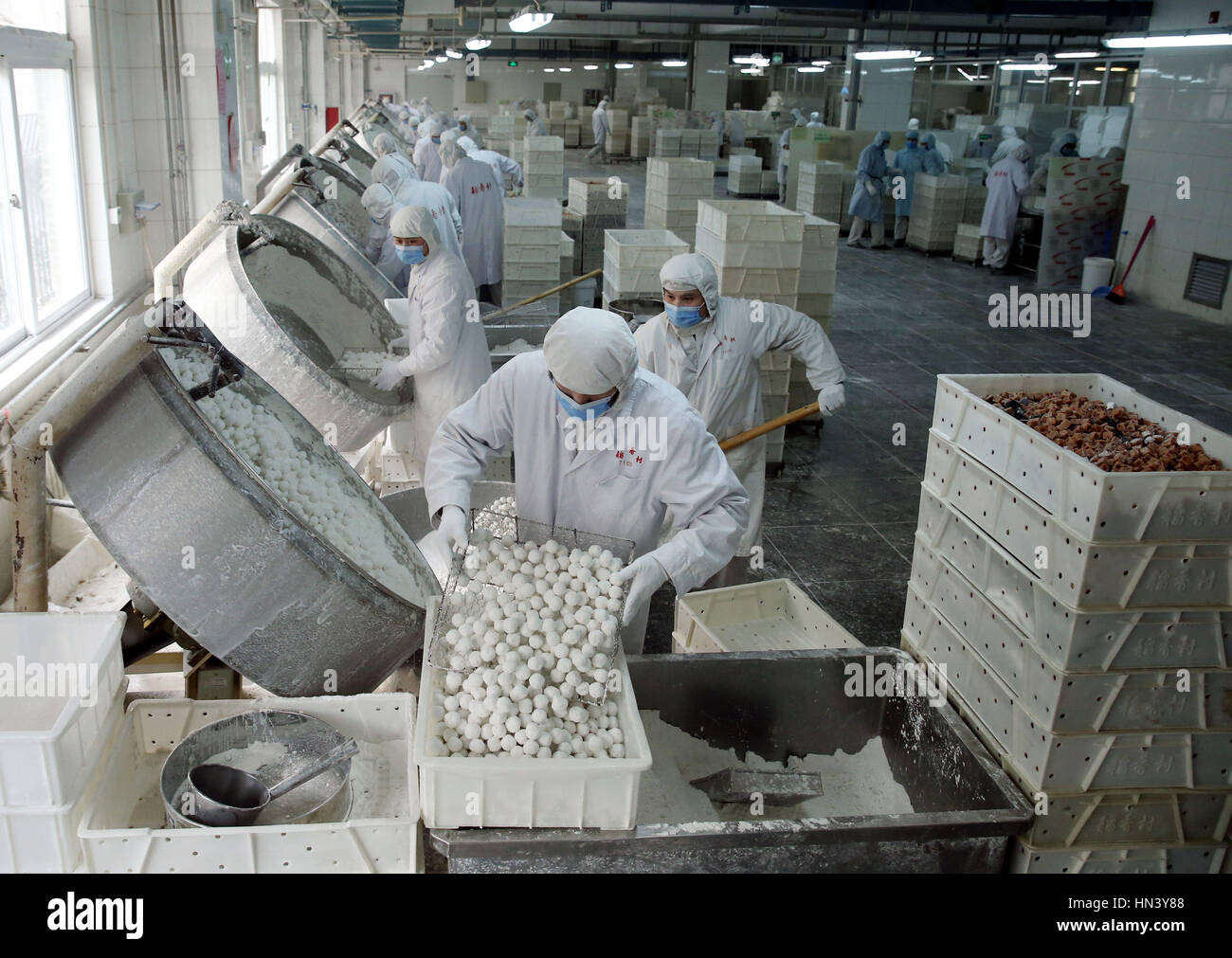 Beijing, China. 7th Feb, 2017. Workers make Yuanxiao, glutinous rice ...