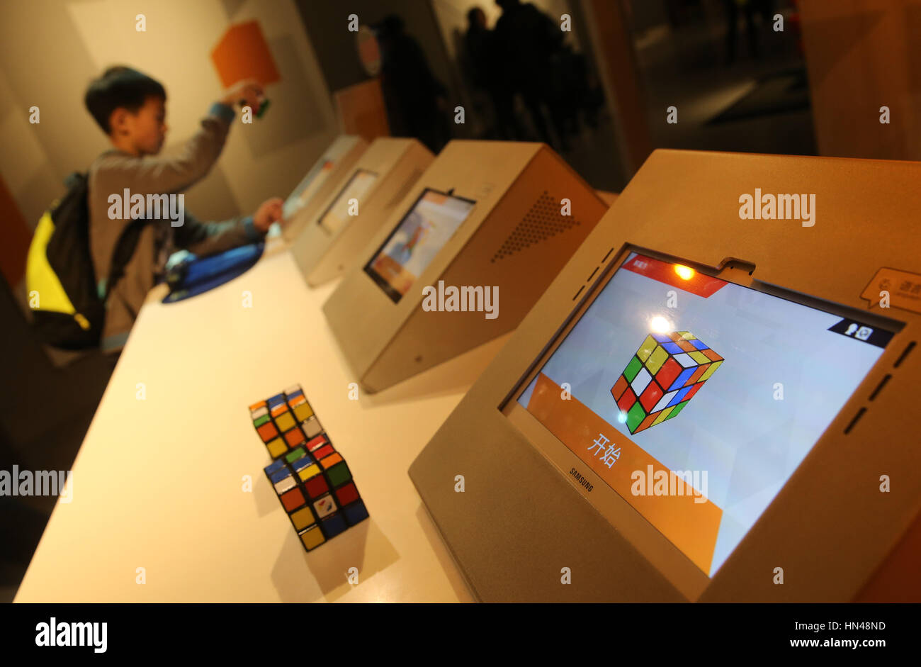 Shanghai, China. 8th Feb, 2017. A young boy learns how to play a magic ...