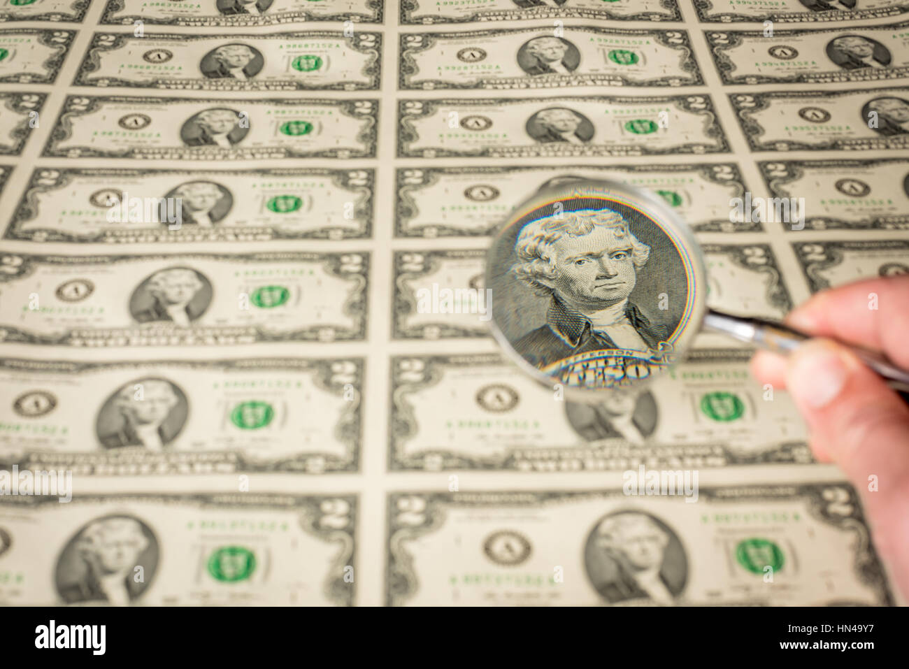 Inspector examines a sheet of two dollar bills Stock Photo - Alamy