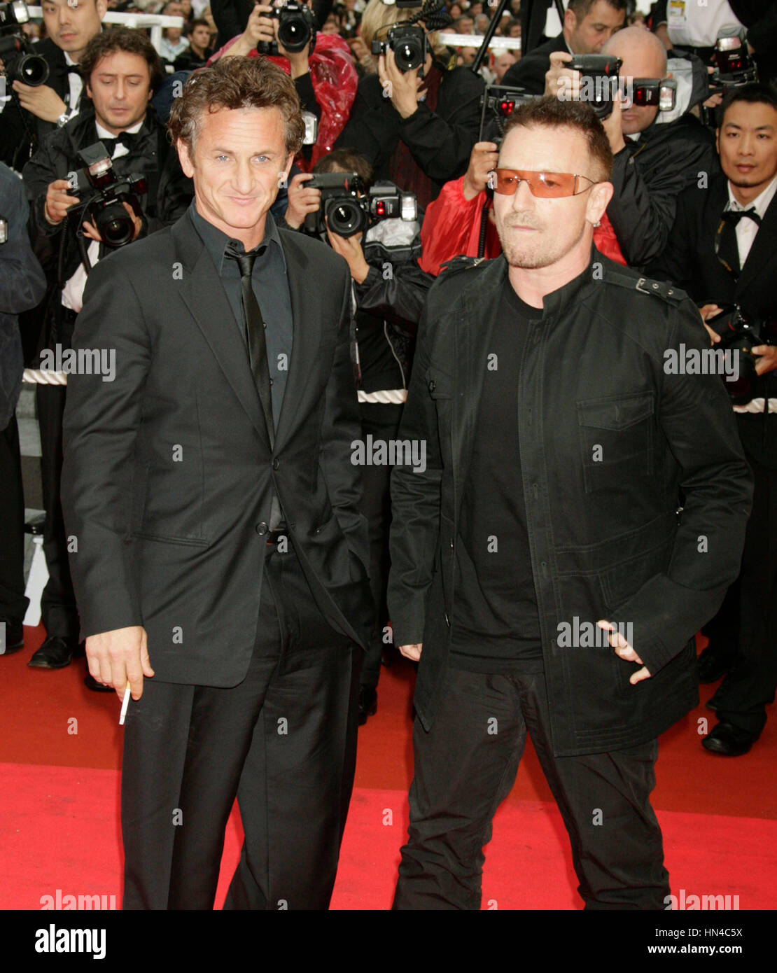 Bono, right, and Sean Penn arrives at the Un Conte De Noel premiere at ...