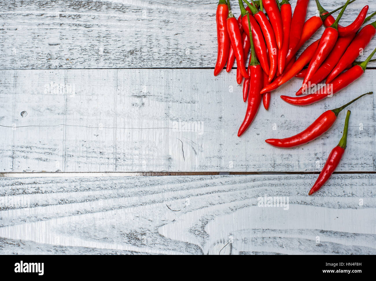 Hot and spicy red chilli on wood table background Stock Photo - Alamy