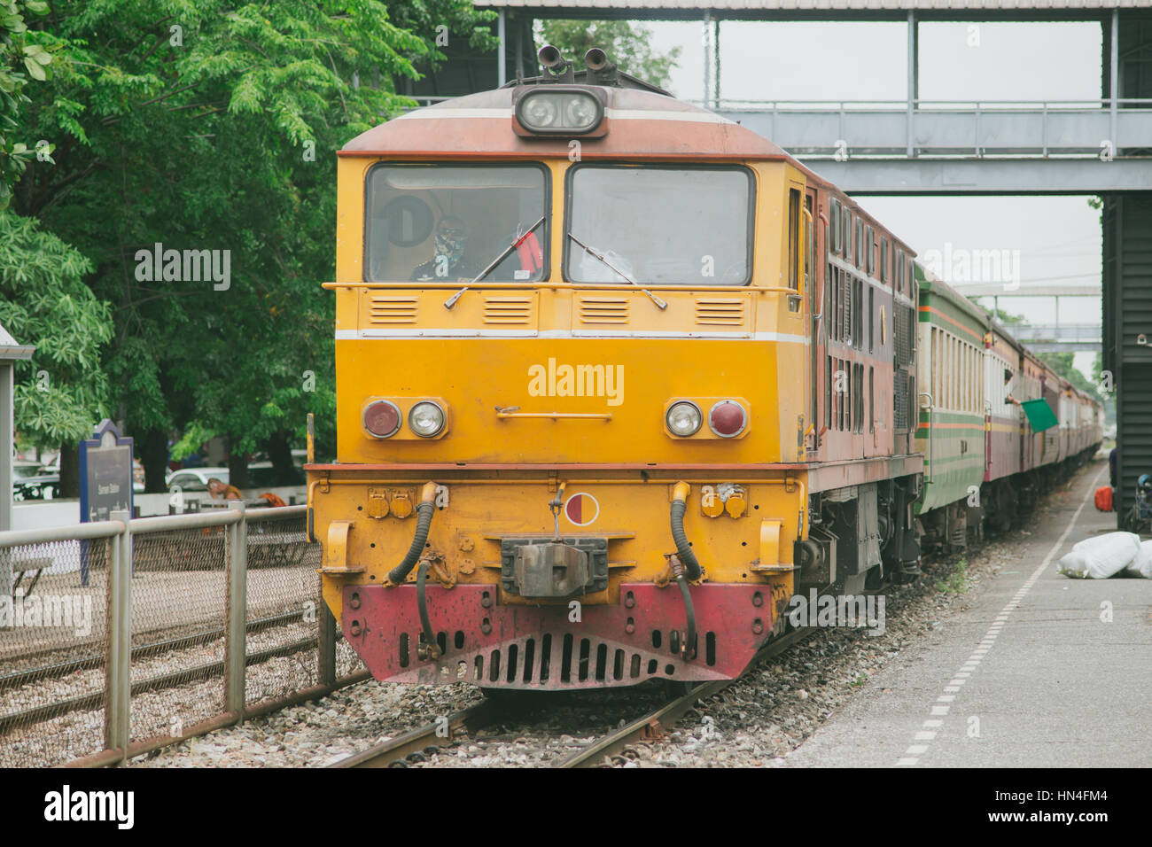 old yellow diesel train in Thailand Stock Photo - Alamy