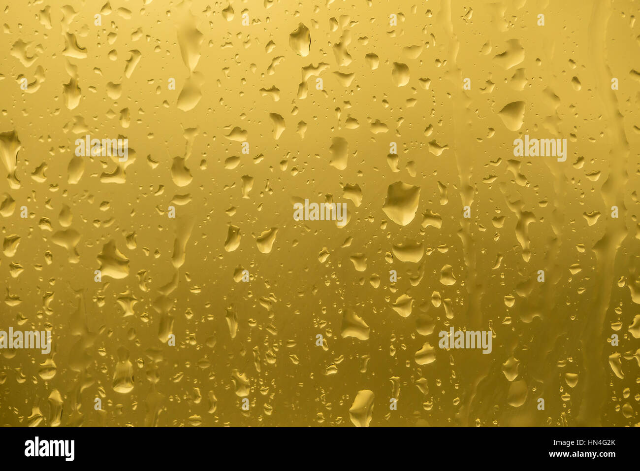 gold color water drop for background Stock Photo - Alamy