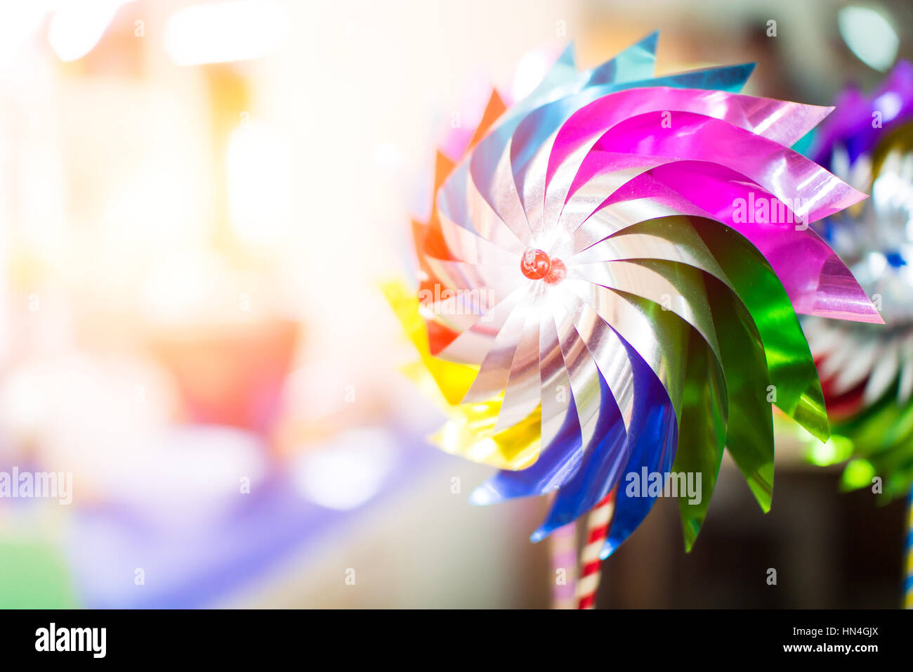 Wind toy with light effect background Stock Photo - Alamy