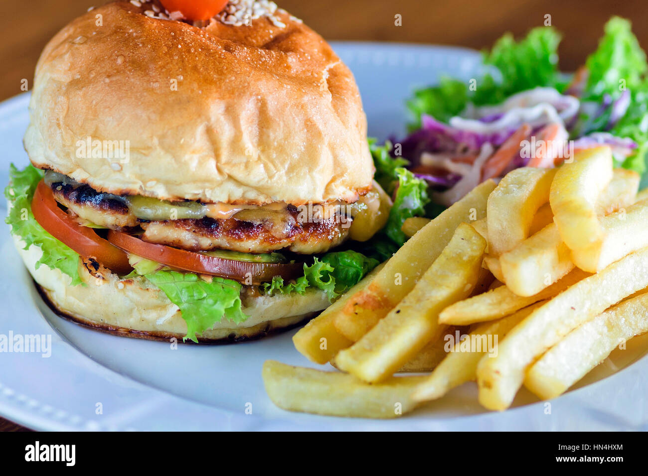 Delicious burger with beef, tomato, cheese and lettuce Stock Photo - Alamy