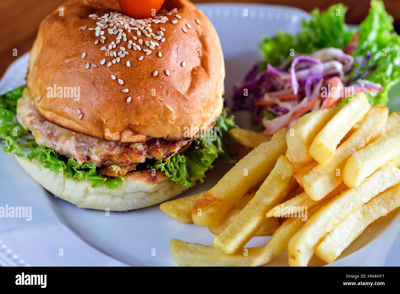 Delicious burger with beef, tomato, cheese and lettuce Stock Photo - Alamy