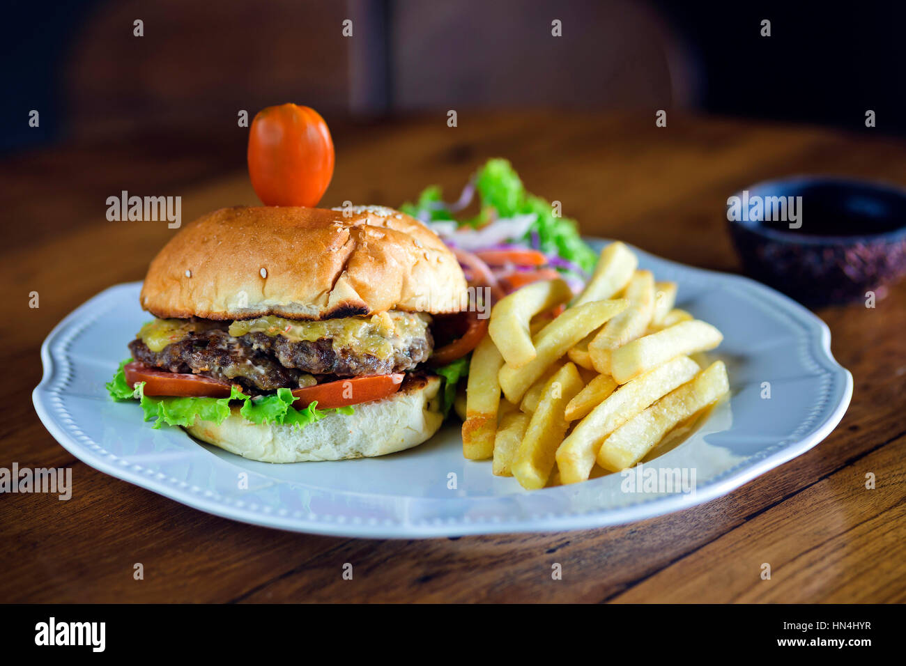 Delicious burger with beef, tomato, cheese and lettuce Stock Photo - Alamy