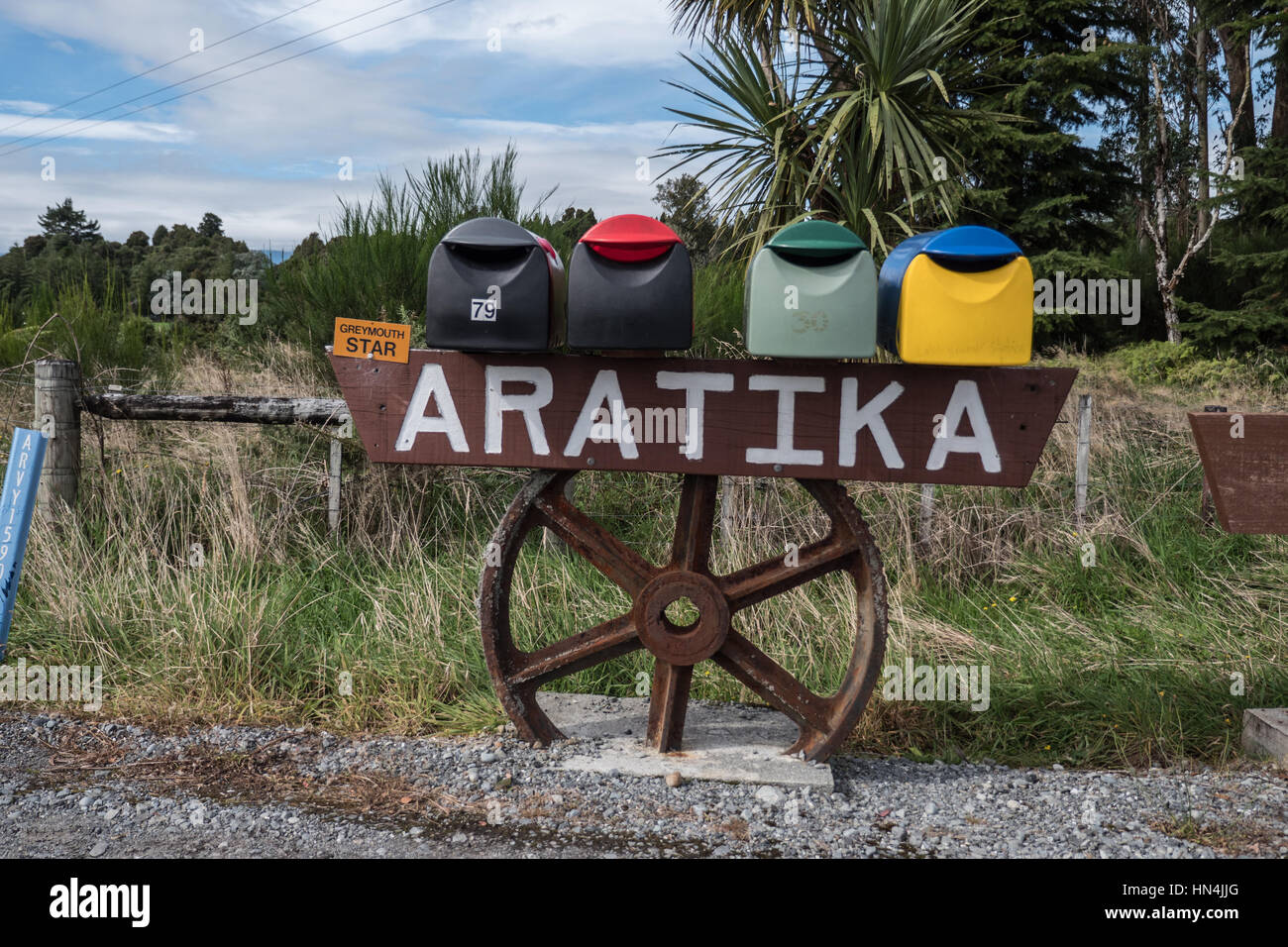 Mail boxes mounted on wheel and frame on the roadside. New Zealand ...