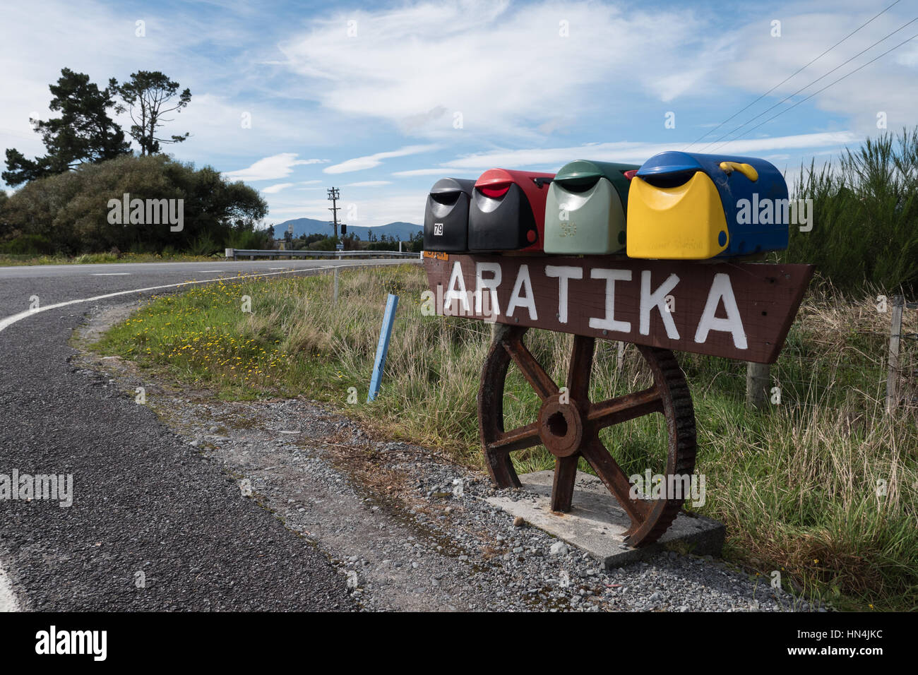 Mail boxes mounted on wheel and frame on the roadside. New Zealand ...