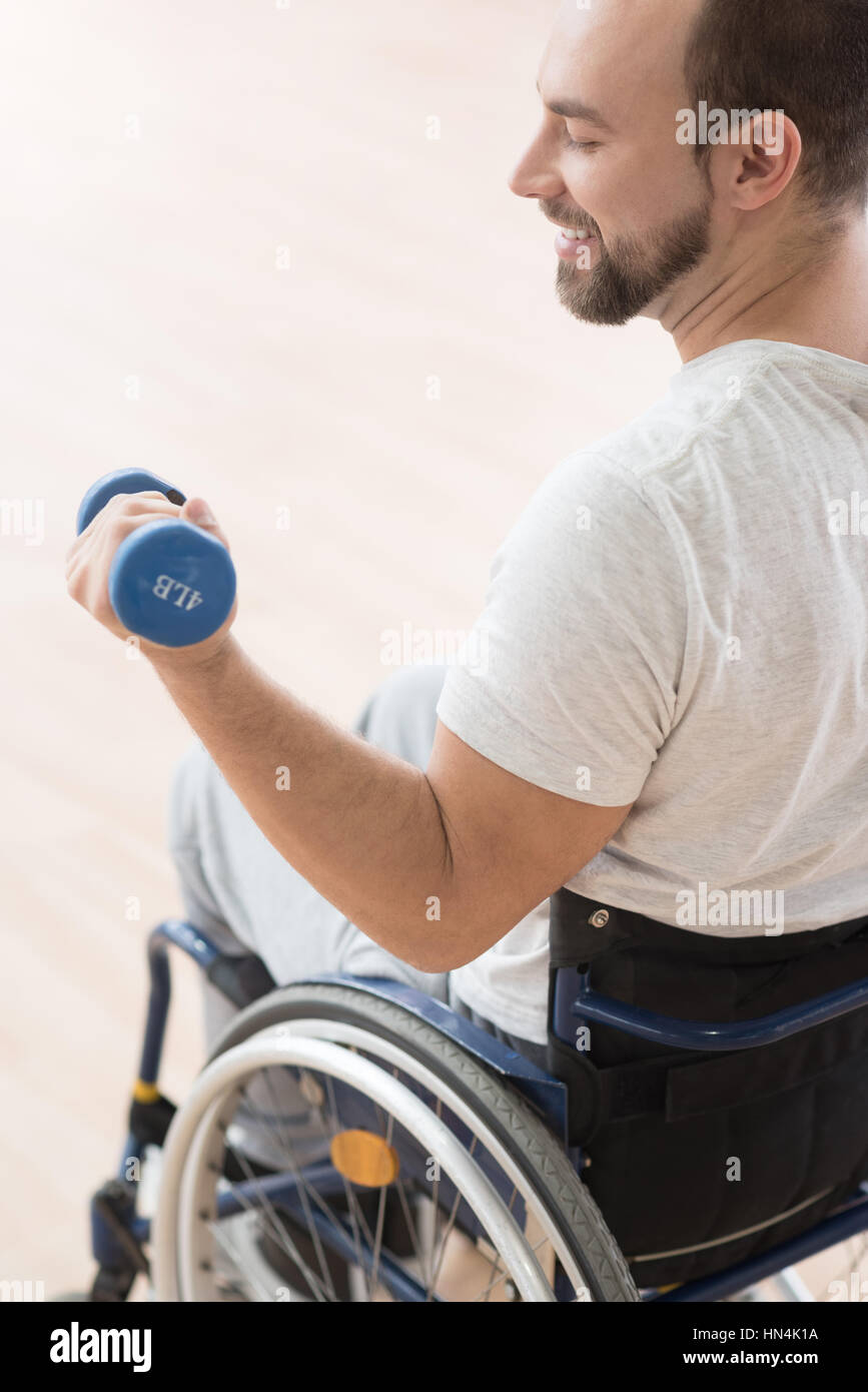Smiling young disabled man training with weights in the gym Stock Photo ...