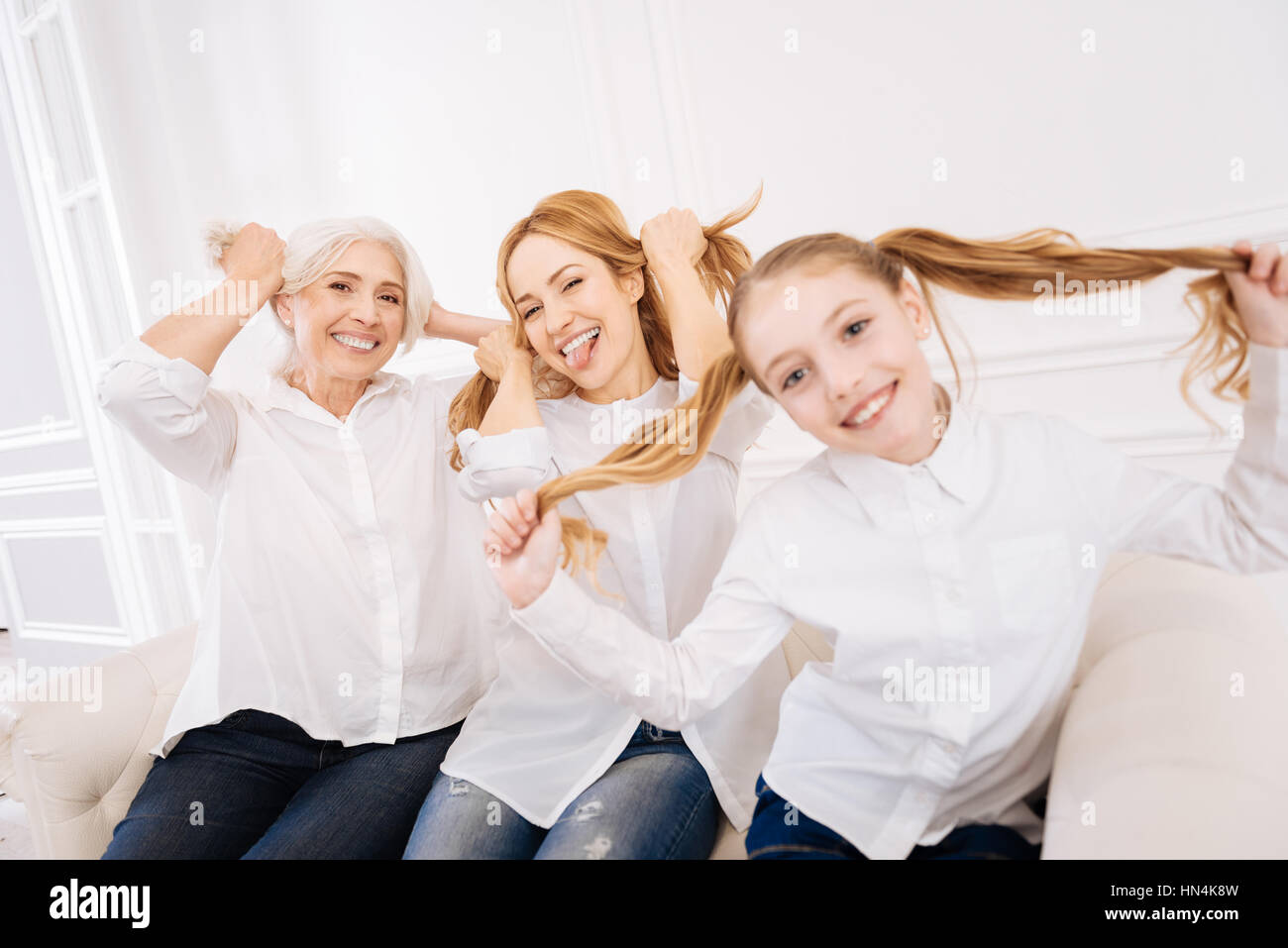 Positive family members having fun at home Stock Photo - Alamy
