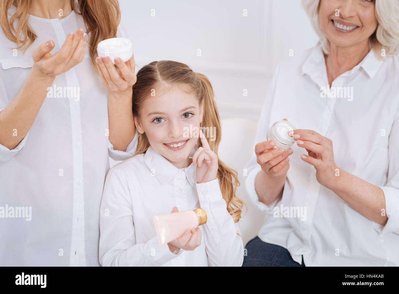 Little girl using beauty cream Stock Photo - Alamy
