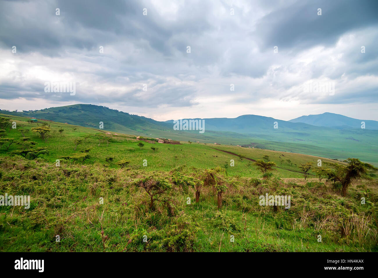 Scenic view in Tanzania with dramatic sky and small village ahead ...
