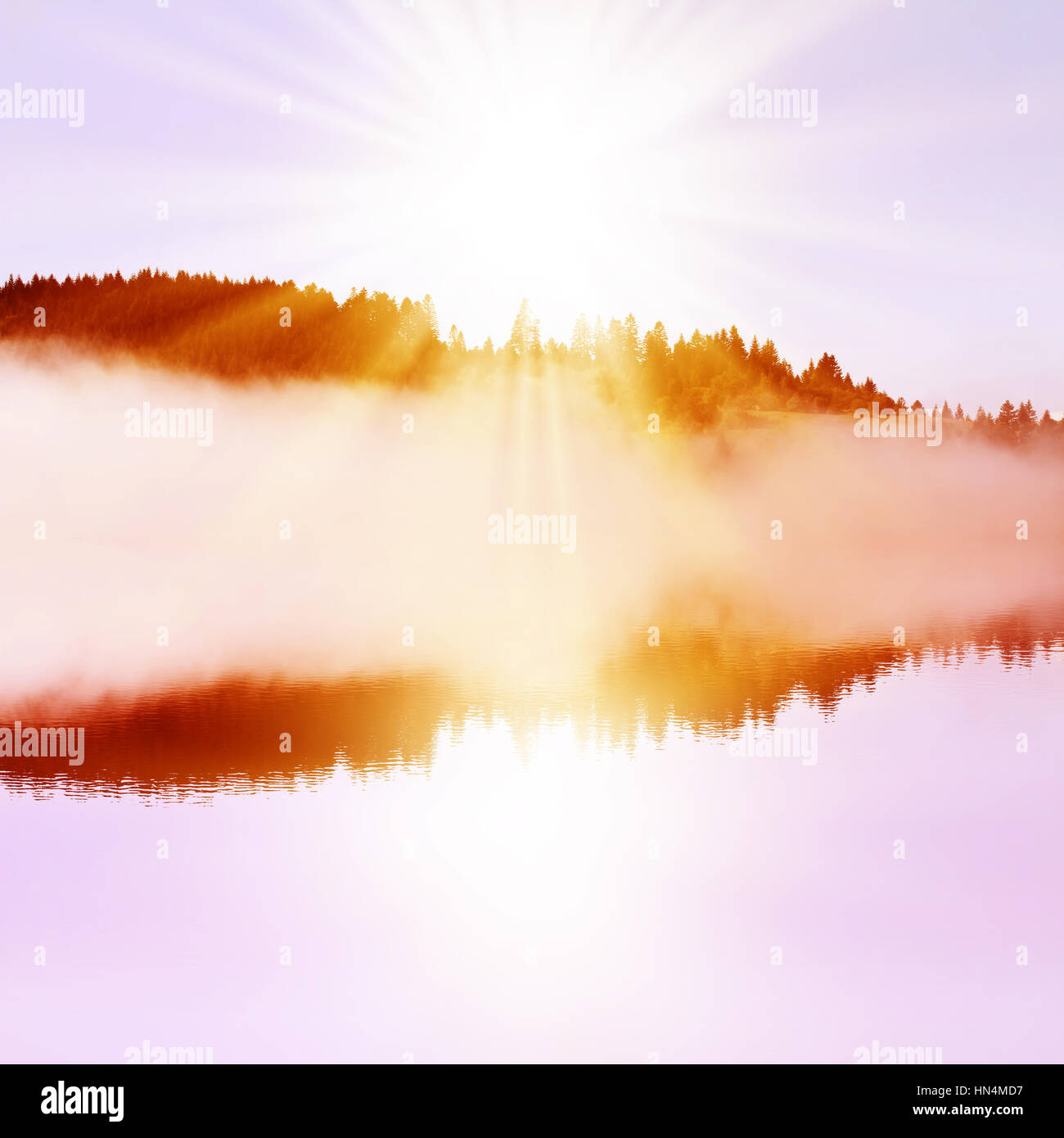 Bright orange sun rays over mountain lake Stock Photo - Alamy