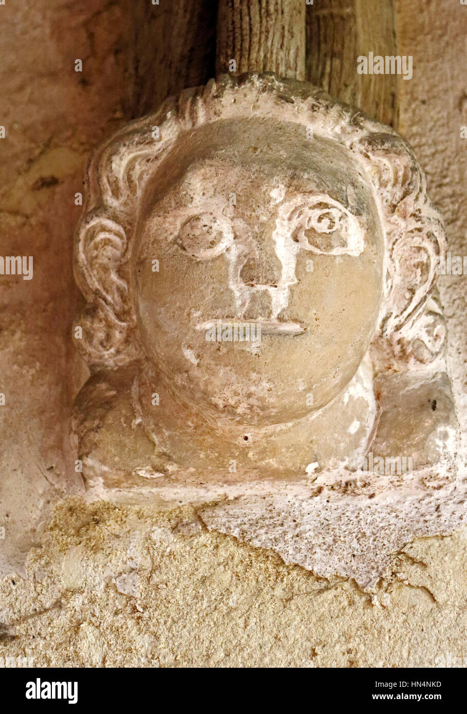 A carved stone head beam support in the south porch of the parish ...