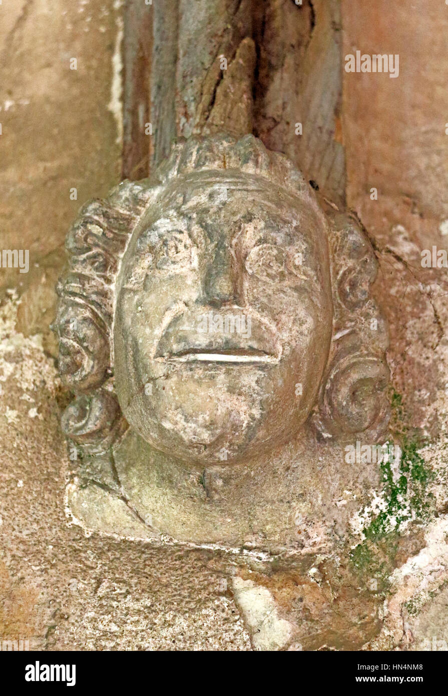 A carved stone head beam support in the south porch of the parish ...