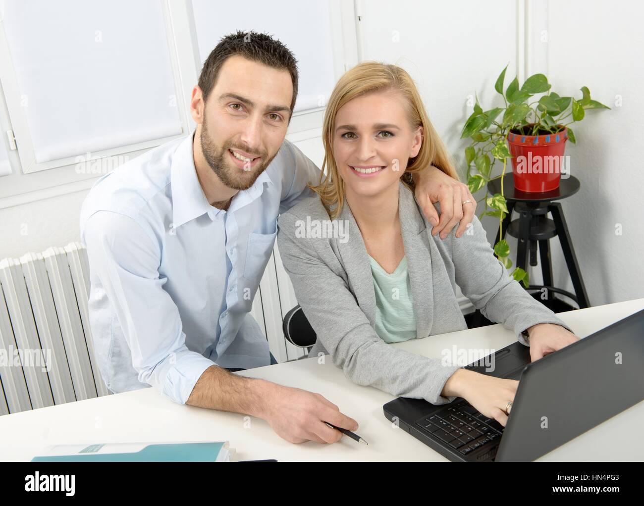 attractive man and beautiful woman business team using laptop computer ...
