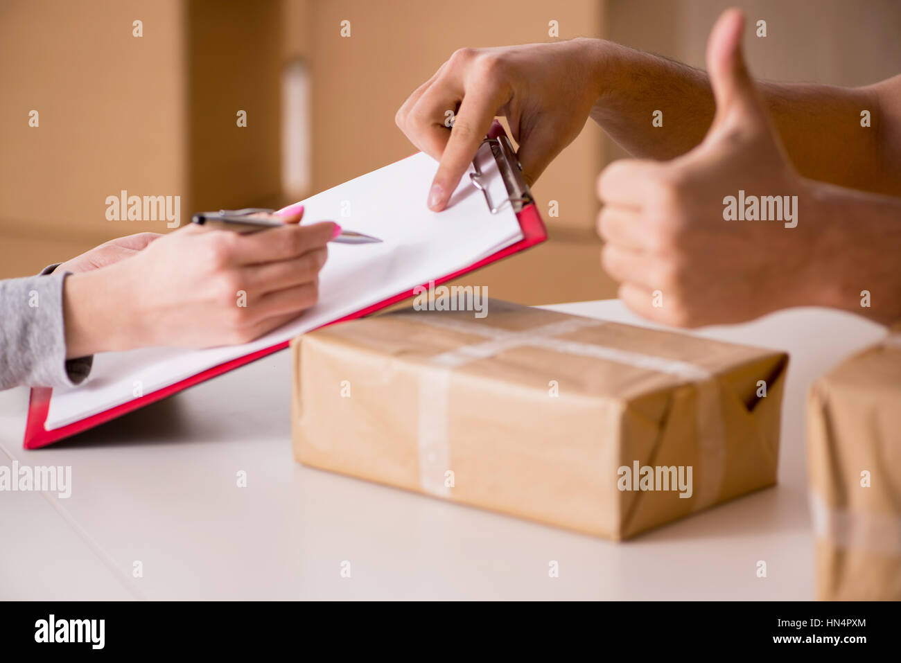 Delivery man delivering parcel box Stock Photo - Alamy