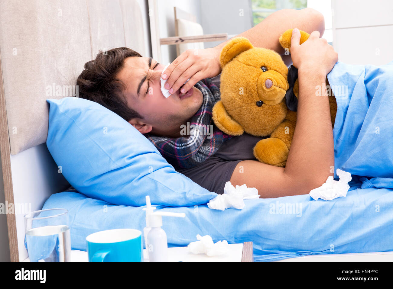 Sick man with flu lying in the bed Stock Photo - Alamy