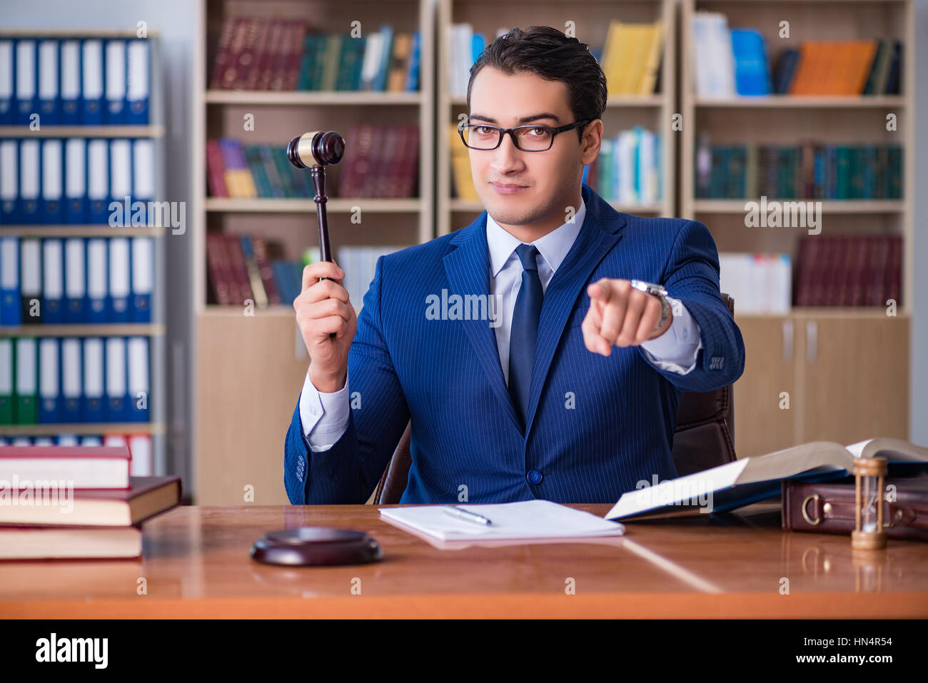 Handsome judge with gavel sitting in courtroom Stock Photo - Alamy