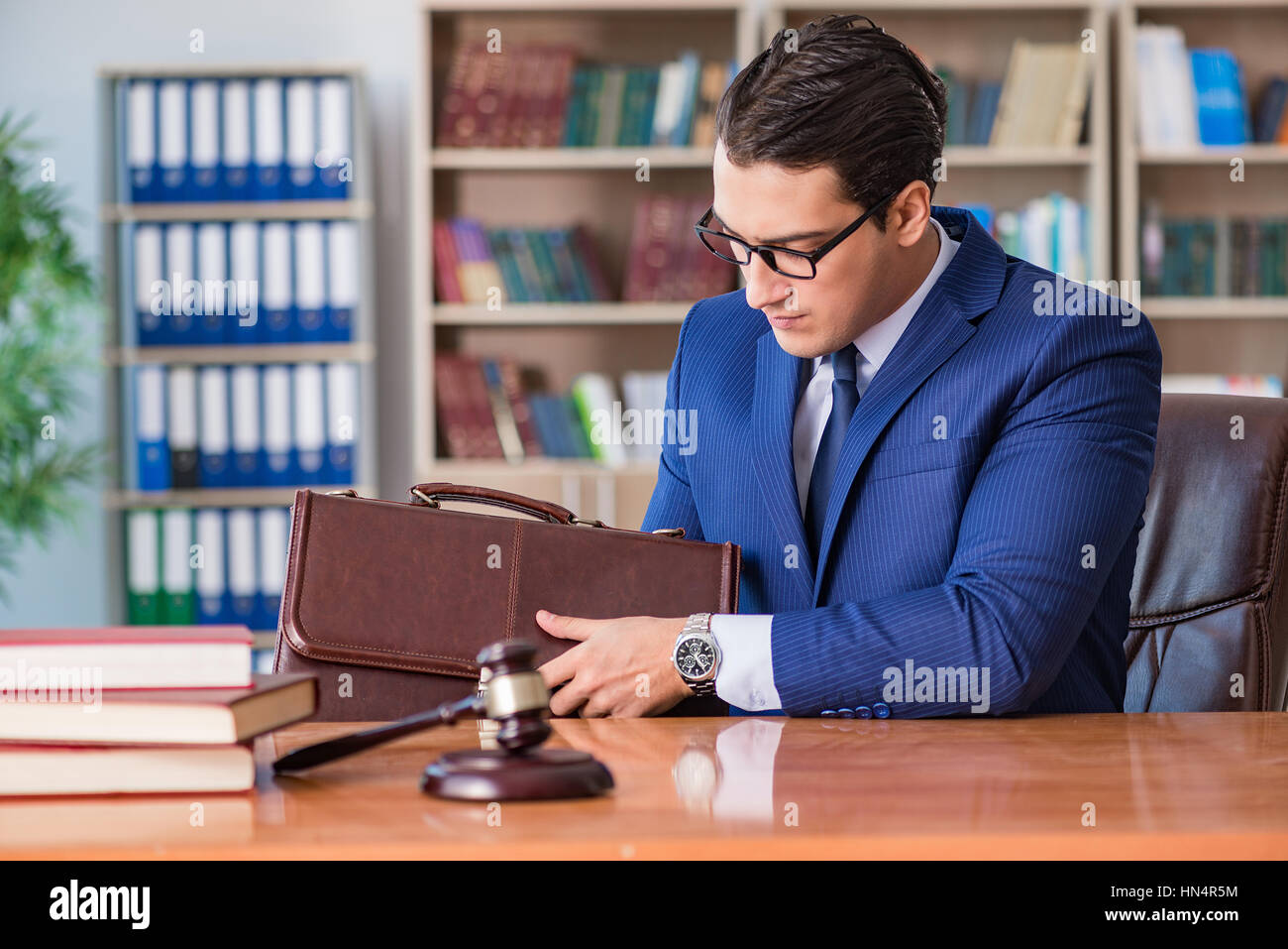 Handsome judge with gavel sitting in courtroom Stock Photo - Alamy