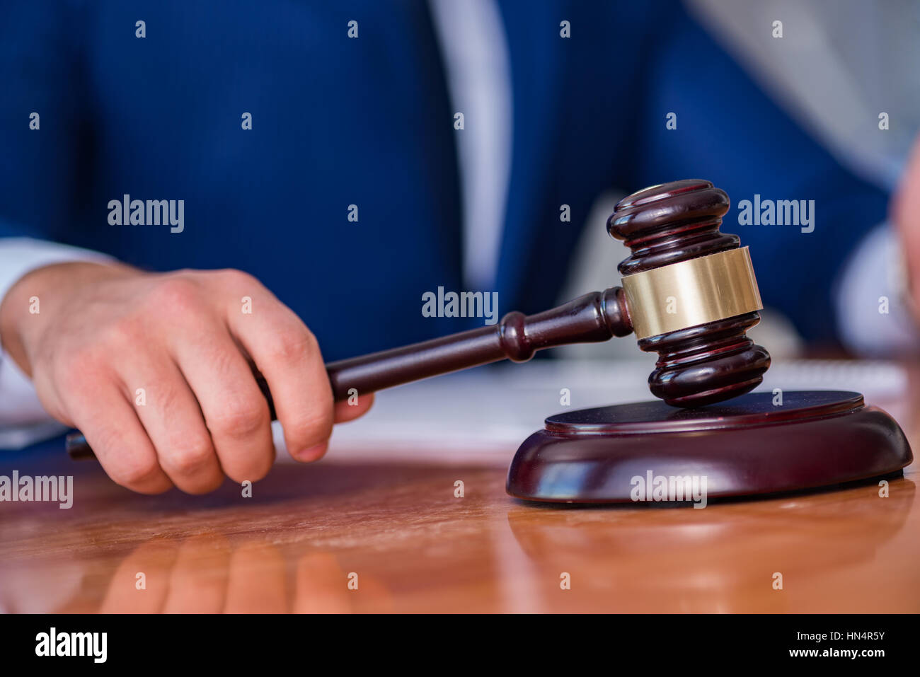 Handsome judge with gavel sitting in courtroom Stock Photo - Alamy