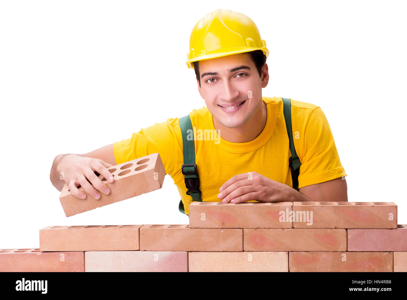 Handsome construction worker building brick wall Stock Photo - Alamy