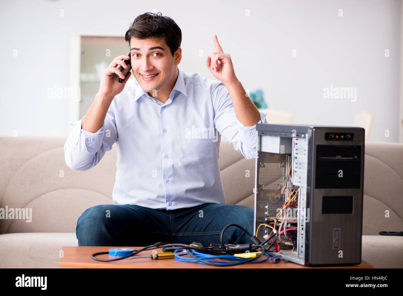 Happy customer resolving his computer problem Stock Photo - Alamy
