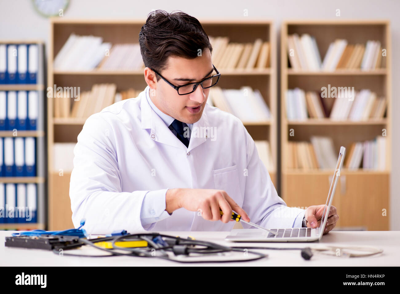 IT technician repairing broken laptop notebook computer Stock Photo - Alamy