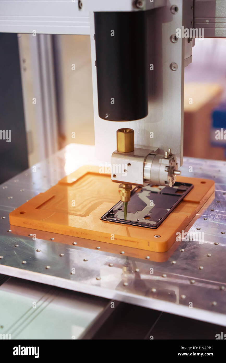 Robot holding glue syringe Injection on phone Stock Photo - Alamy