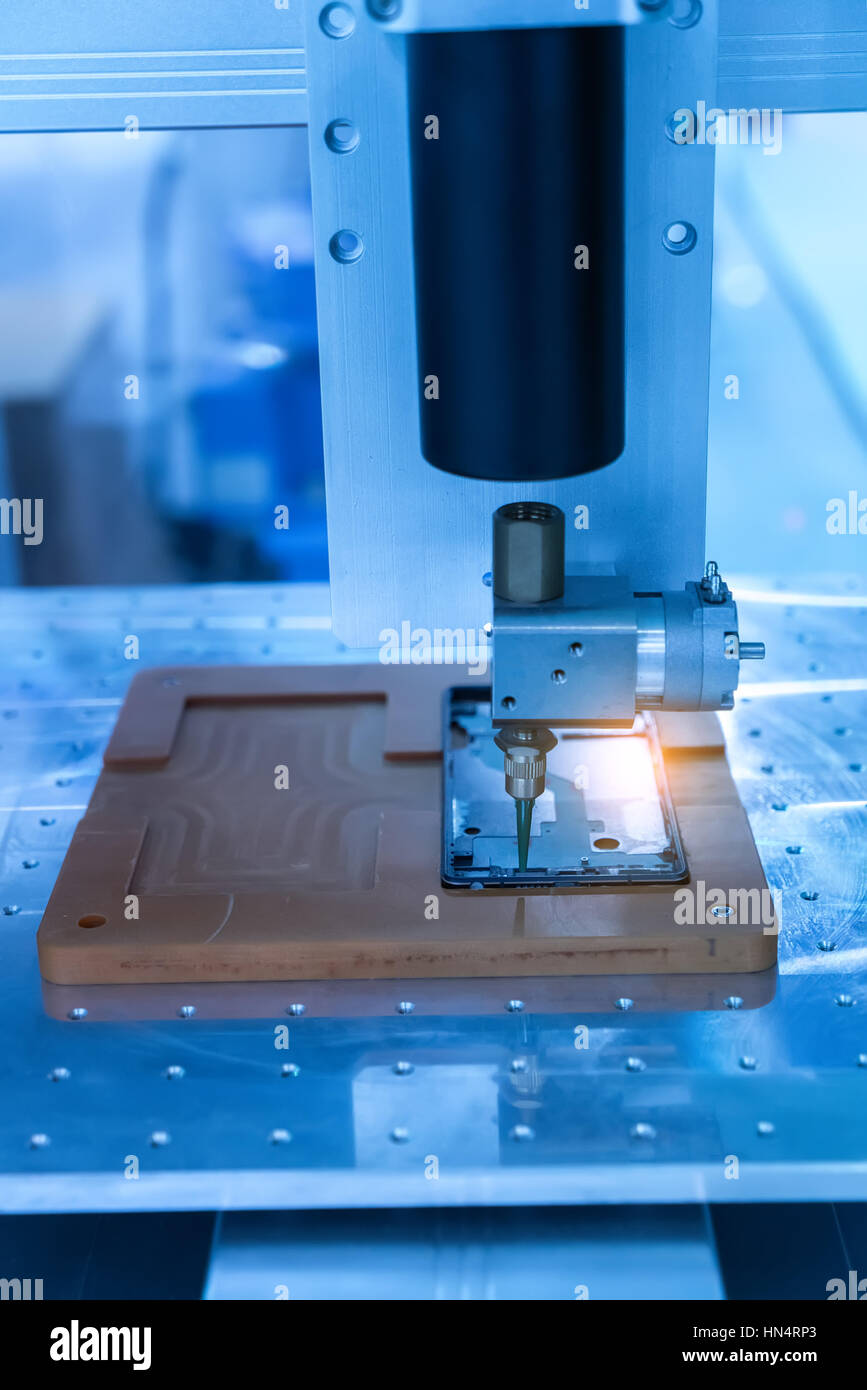 Robot holding glue syringe Injection on phone Stock Photo - Alamy
