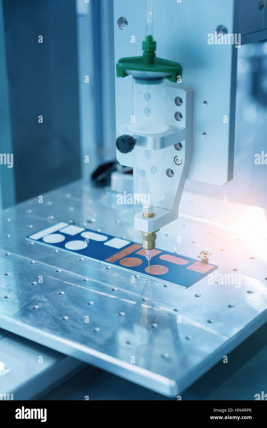 Robot holding glue syringe Injection Stock Photo - Alamy