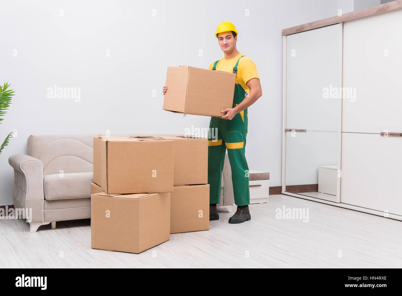 Transportation worker delivering boxes to house Stock Photo - Alamy