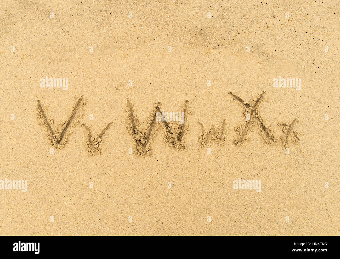 alphabet letters handwritten in sand on beach Stock Photo - Alamy