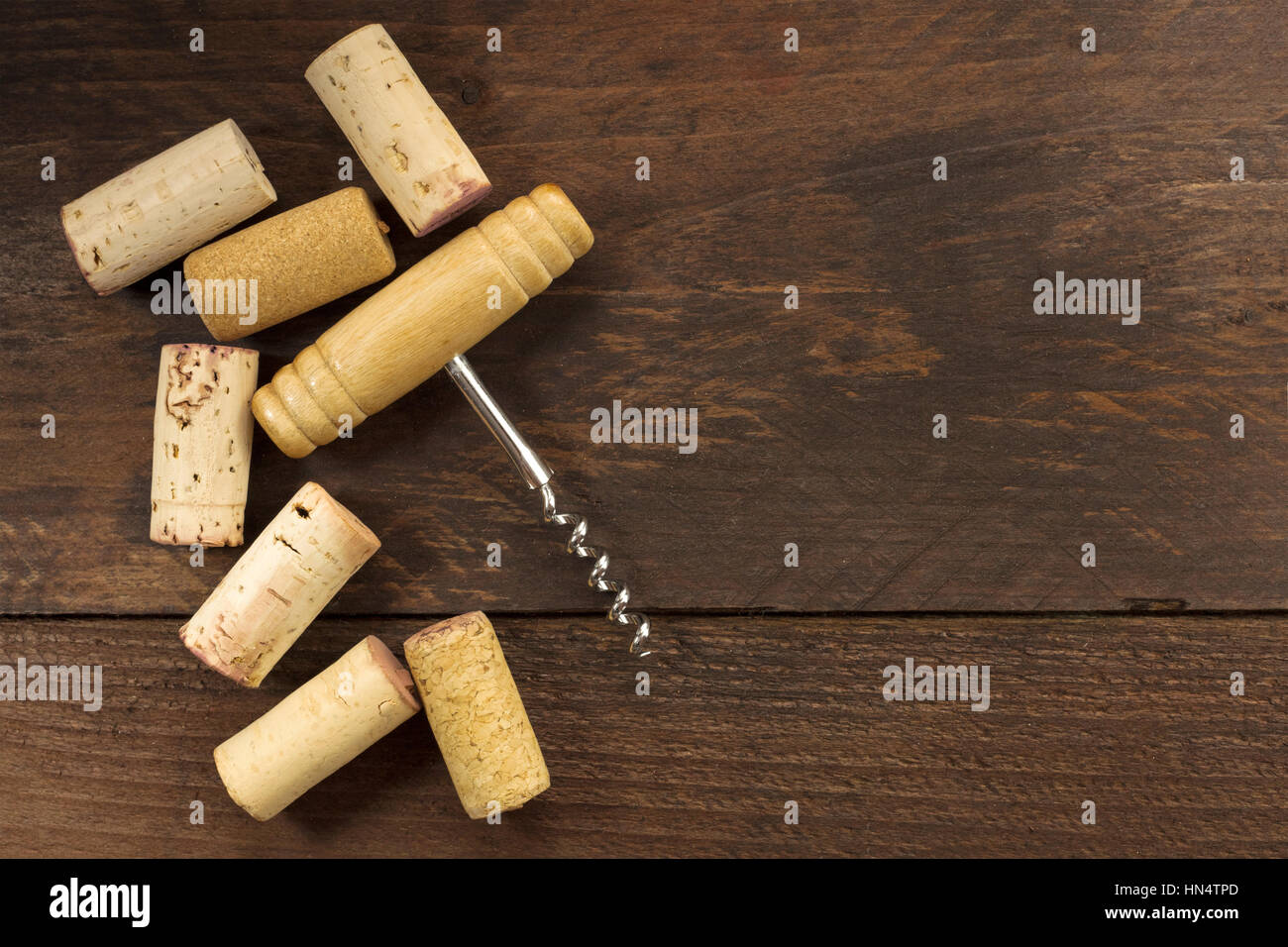 A photo of an old-fashioned corkscrew with a corks, shot from above on ...