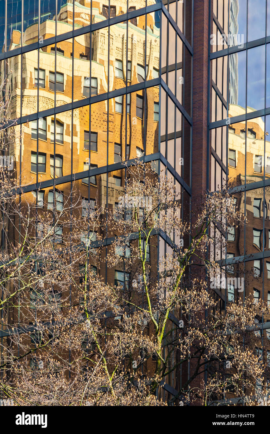 The Burrard Building refected in the glass of a Vancouver office tower ...