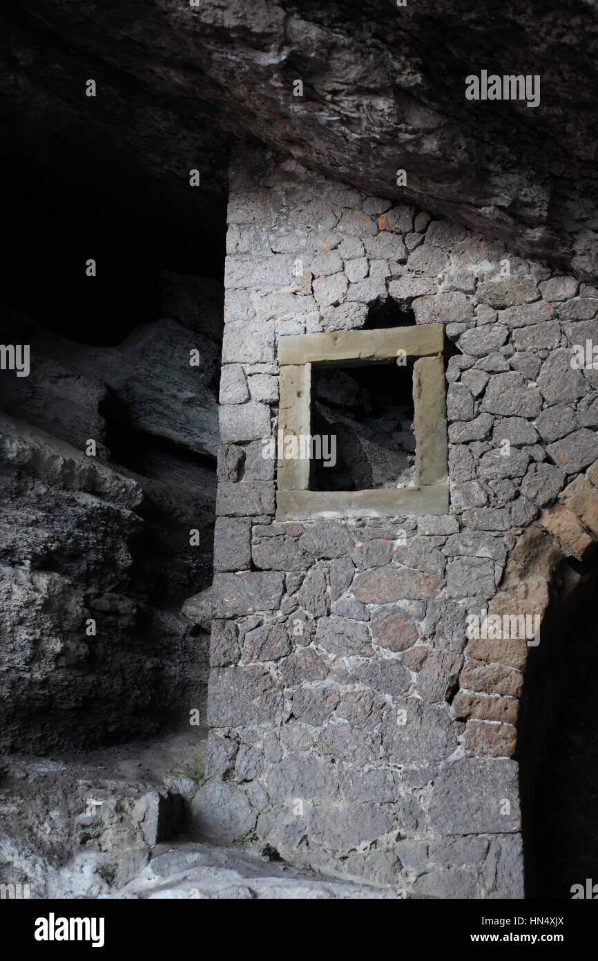 Fragment of the ancient stone wall with window in grotto Stock Photo ...