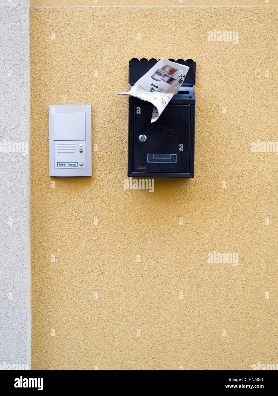 Junk mail and advertising on houses letter boxes Stock Photo - Alamy