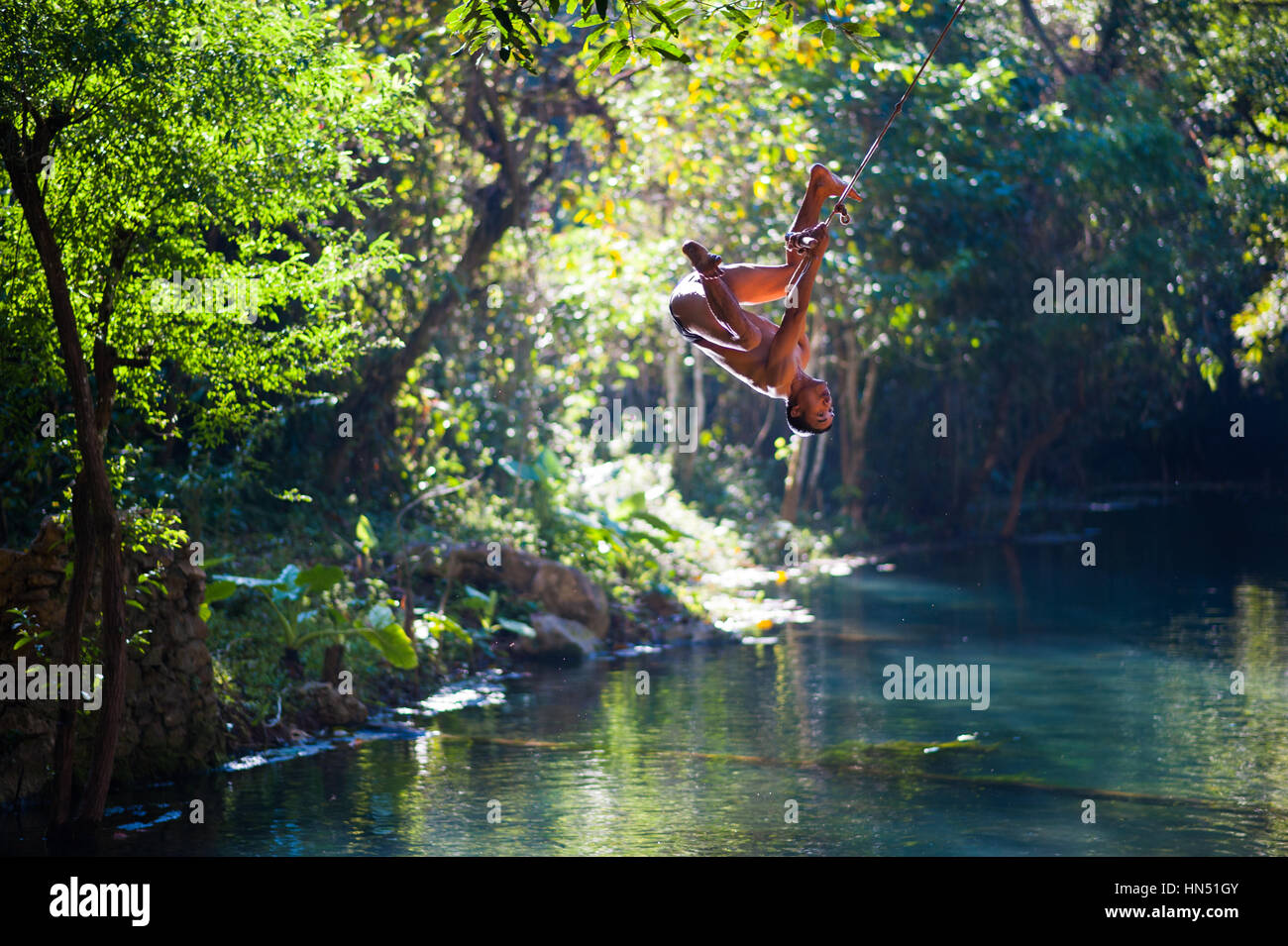 Asian man jumping in the water Stock Photo - Alamy