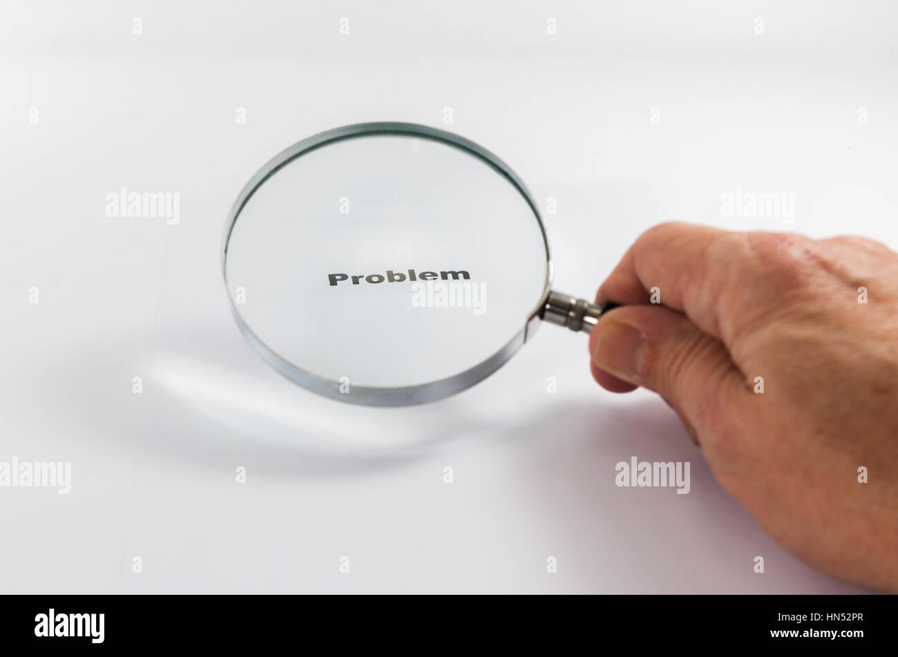 hand with magnifying glass looking at the problem Stock Photo - Alamy