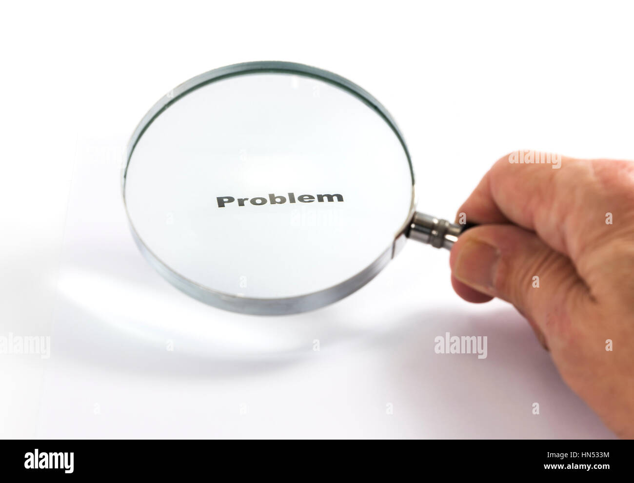 hand with magnifying glass looking at the problem Stock Photo - Alamy