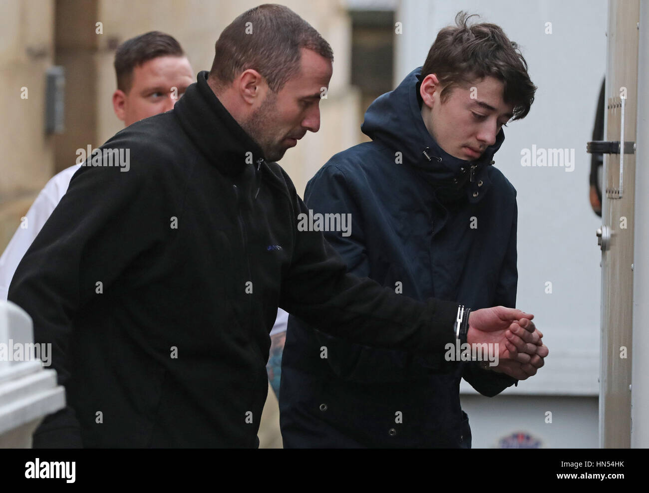 Michael March (right) is escorted in handcuffs from Newcastle Crown ...