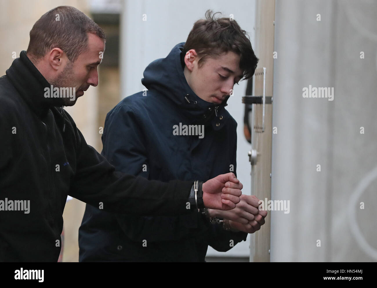 Michael March (right) is escorted in handcuffs from Newcastle Crown ...