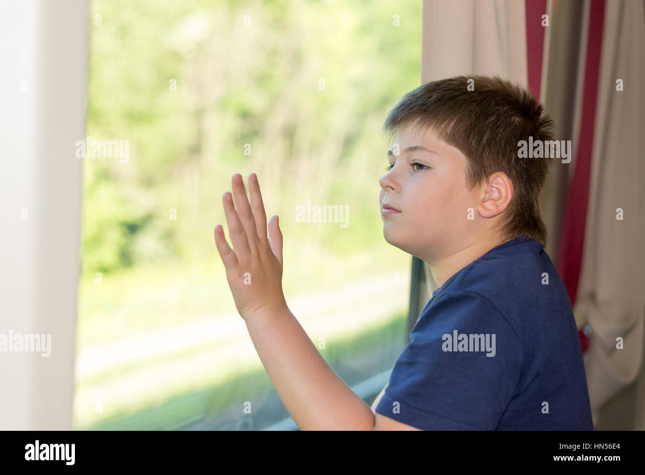 The boy looks out the window on the train Stock Photo - Alamy