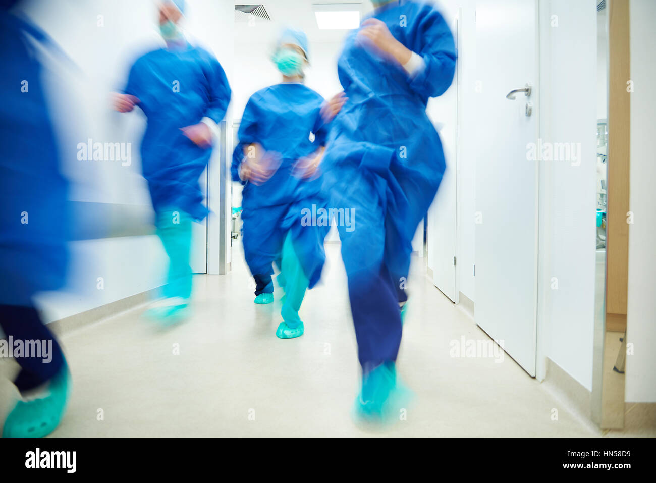 Running doctors going to help a patient Stock Photo - Alamy